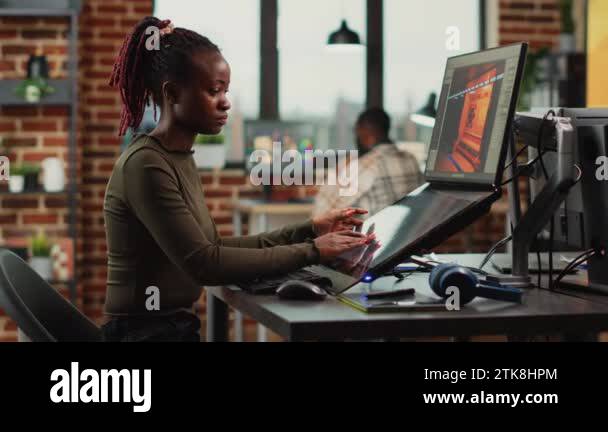 African american woman designing game interface on computer with ...