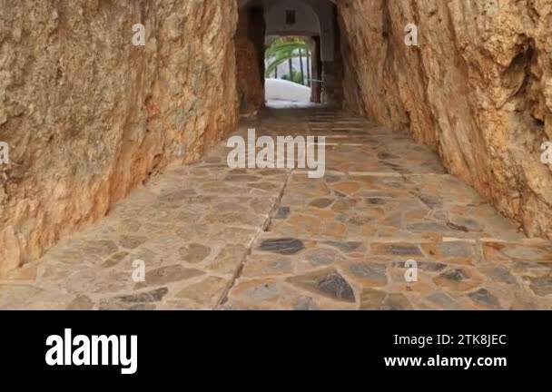 Exit from the medieval castle of Guadalest through the main gate, cut ...