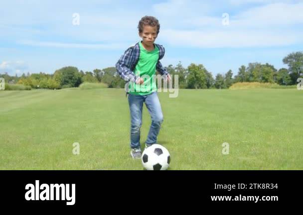 Skillful adorable school age African American boy football player ...