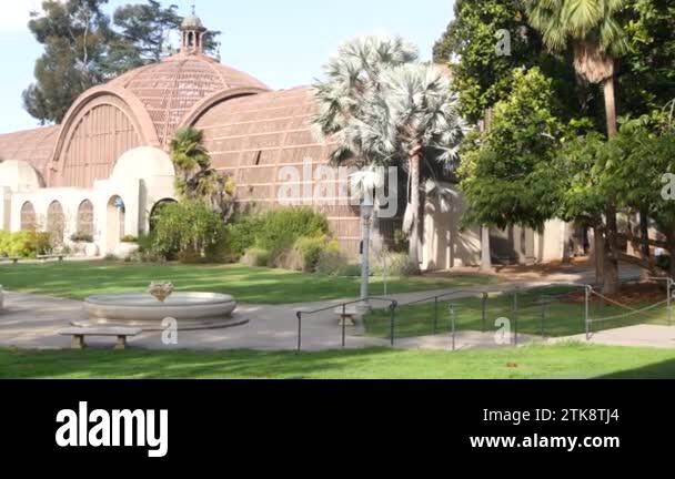 Botanical building exterior or facade in garden, green grass lawn, palm ...