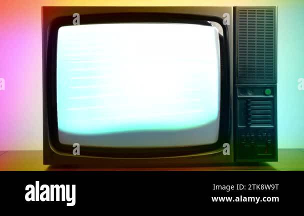 Vintage TV on colourful lights background, blinking screen and ...