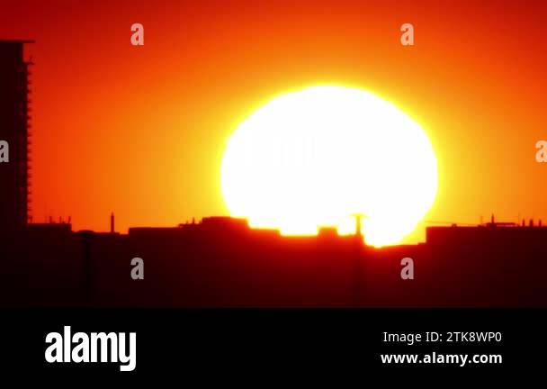 Sunset sun setting behind American downtown skyline silhouette. Epic ...