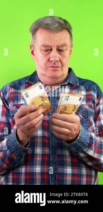 Senior man counting cash of 50 euro money banknotes and smiling pleased ...