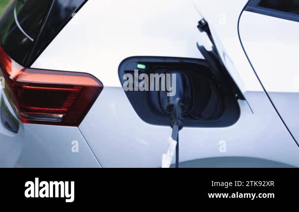 Electric vehicle charging port plugging in EV modern car. Charging ...