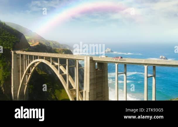 Beautiful colorful rainbow appears above arch Bixby bridge with West ...
