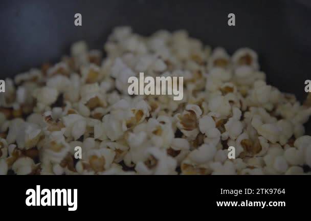 Slowmotion of homemade popcorn popping wildly from a frypan. Crunchy ...