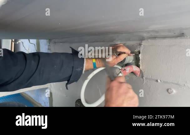 Plumbing work on installing the outlet of cold and hot water from the ...