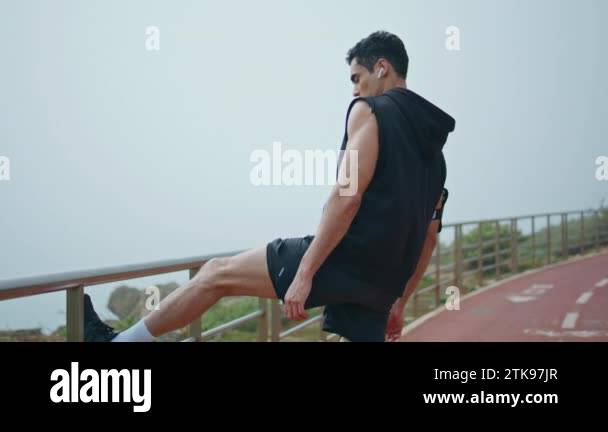 Athlete person doing exercise on running track. Muscular fit guy ...