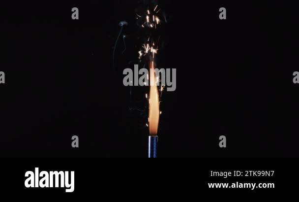 Video of torch with yellow flame and sparks and copy space on black ...