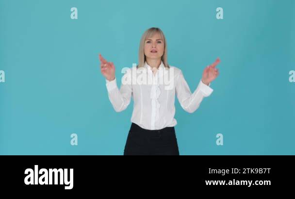 Hopeful Caucasian woman is depicted crossing her fingers in hope on a ...