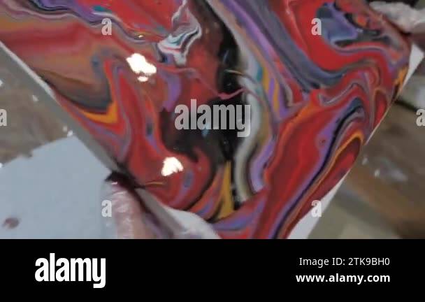 Painting with liquid ink. Abstract ink painting. The artist creates a ...