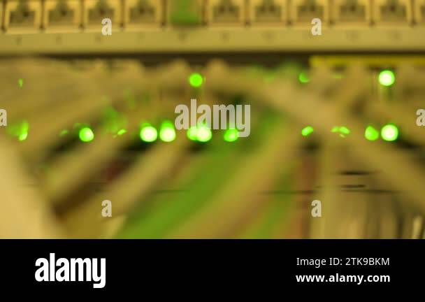 Blurred view of blinking colorful lights or LED lights in a server rack ...