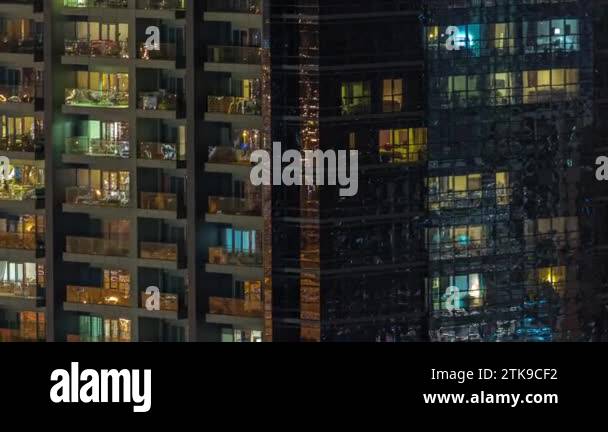 Windows of apartment building at night timelapse, the light from ...