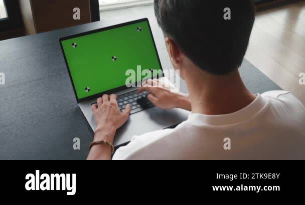 Over the shoulder shot business man using computer with mock-up green ...