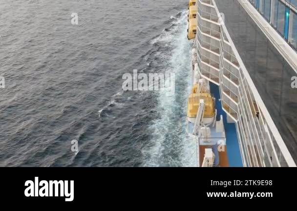 Lifeboat on giant cruise ship view down to ocean surface with waves ...