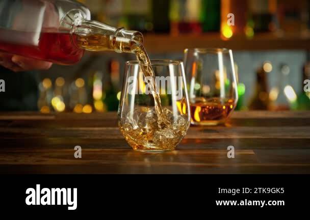 Super slow motion of pouring whisky into glass with speed motion ...
