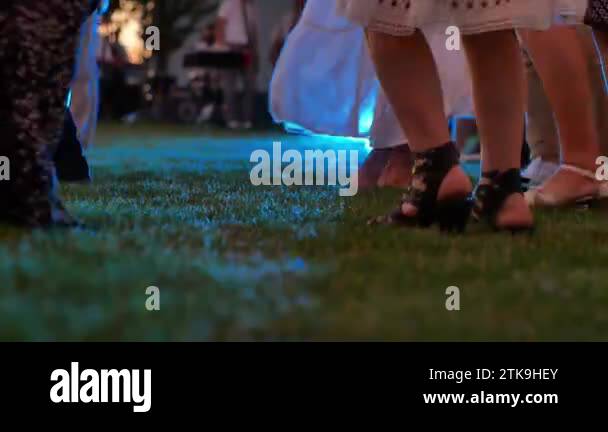 A close-up of the feet of dancing people against the backdrop of ...