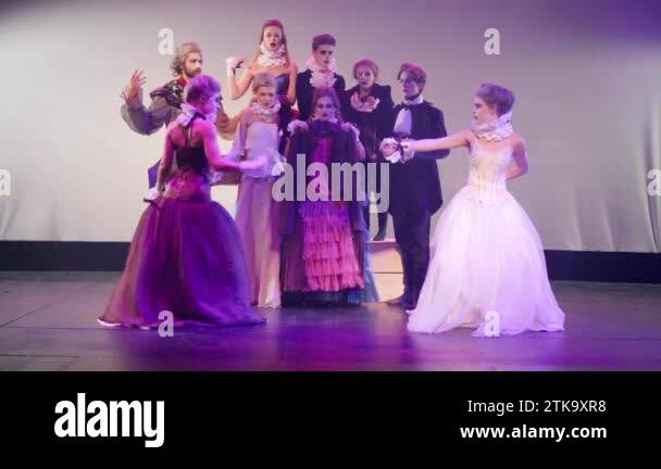 Wide shot actresses in princess dresses imitating sword fight on stage ...