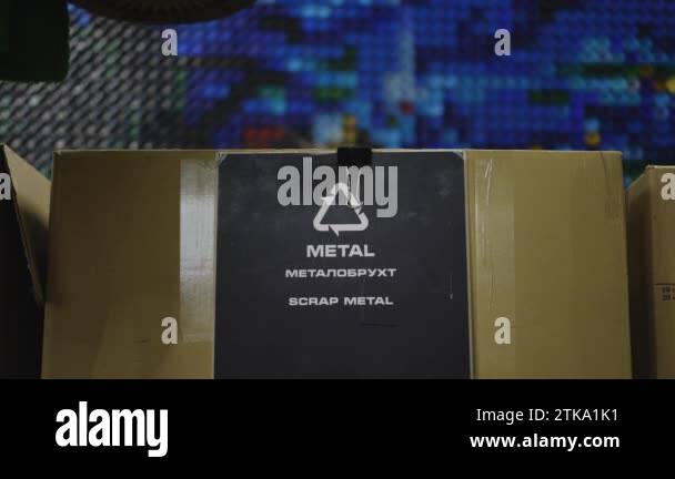 Closeup Scrap metal in English and Ukrainian on box with female hands ...