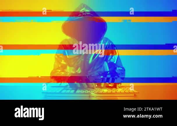 Anonymous computer hacker wearing silver hooded jacket typing on ...