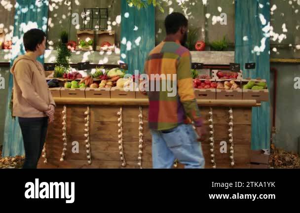 People enjoying shopping at local farmers market, checking fresh farm ...