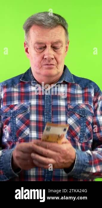 Senior man counting cash of 50 euro money banknotes and angrily returns ...