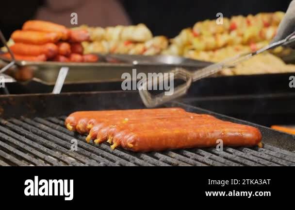 Grilling sausages in traditional Christmas fair in Europe. Close-up of ...
