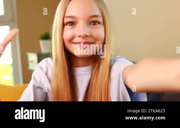 Pre Teen Girl Making Selfie Photos On Her Smartphone In Cozy Living