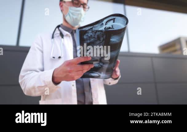 Male doctor examines x-ray of patient chest with CT scan film ...