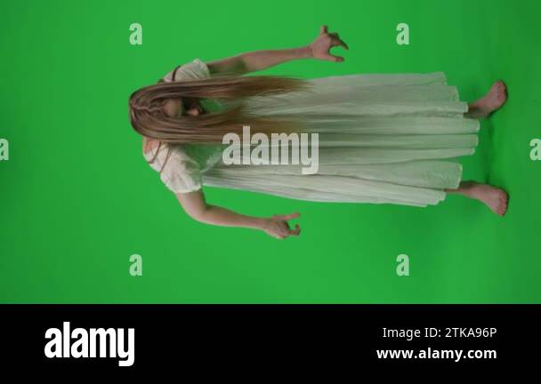 Full-size vertical green screen, chroma key video of a posessed female ...