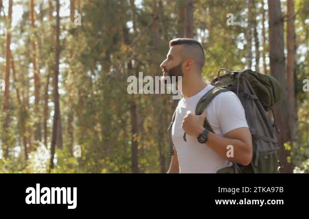 Caucasian male hiker lifting his hand upwards at the forest. Young man ...