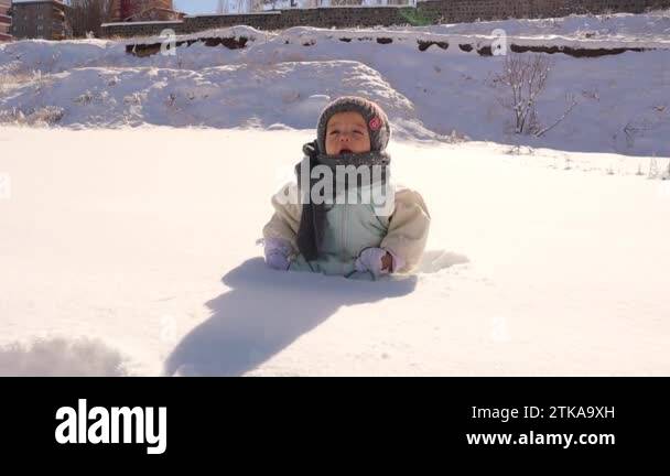 Baby experiences ice for the first time by touching and tasting it ...
