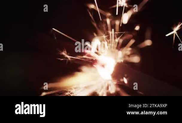Video of close up of sparkler and copy space on black background. Fire ...