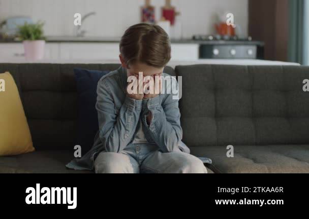 Portrait of a sad, anxious child who is bored at home.A scared, bored ...