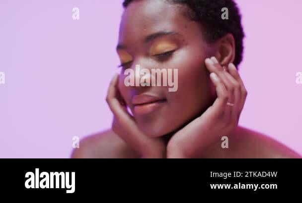African american woman with short dark hair in blue and pink light ...