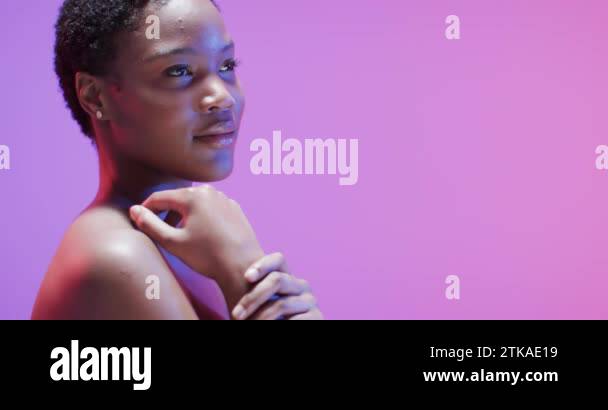 African american woman with short dark hair in blue and pink light with ...