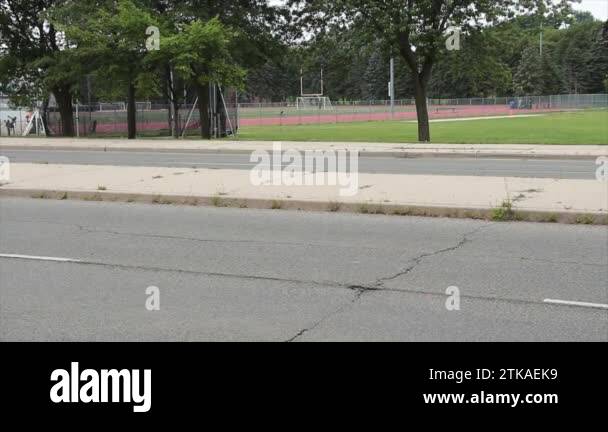 football soccer stadium field track shot from across road street with ...