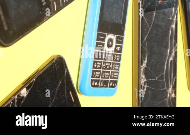 Cracked mobile phones with a cracked screen. Recycling of mobile phones ...