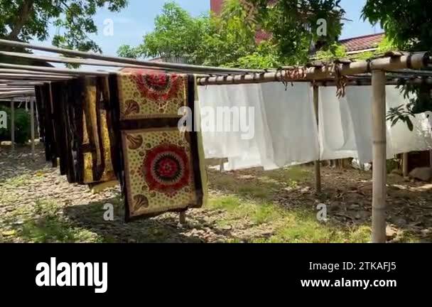 The process of drying batik cloth during the day. The cloth is dried ...