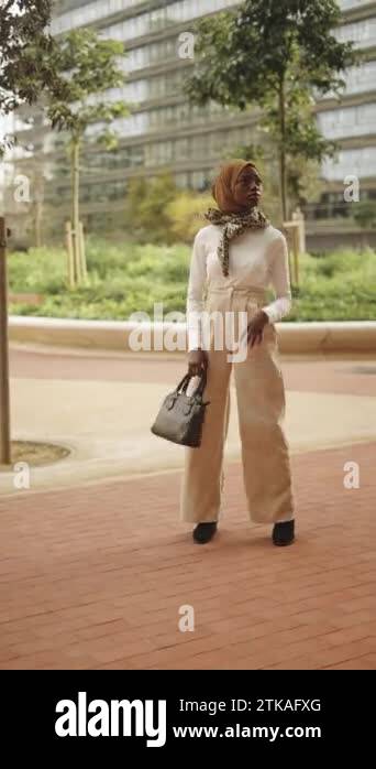 Full body of self assured female dressed in smart casual outfit and ...
