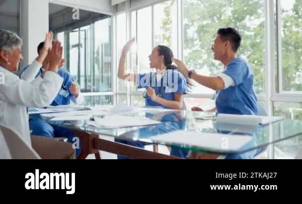 Team, doctors and celebration in hospital meeting, team building or ...