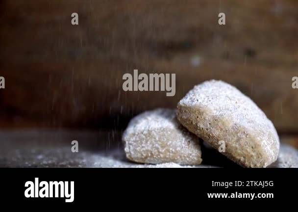 Flour falling on fresh bread shaped as loafs of bread. Flour dropping ...