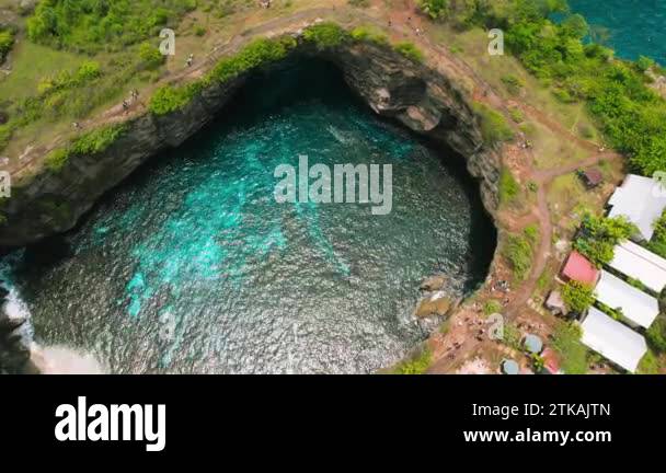 Broken beach in Bali. Aerial top down view of natural swimming pool and ...