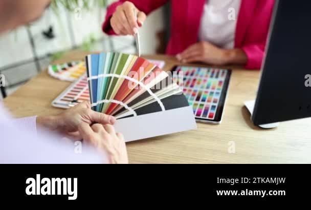 A man chooses with a designer a color of a palette, a close-up. Concept ...