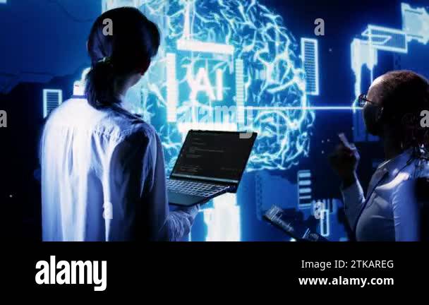 IT team members programming scripts on laptop, employing AI machine ... IT team members programming scripts on laptop, employing AI machine ...