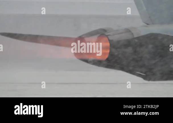 Flames from afterburners of jet engines of a fighter plane taking off ...