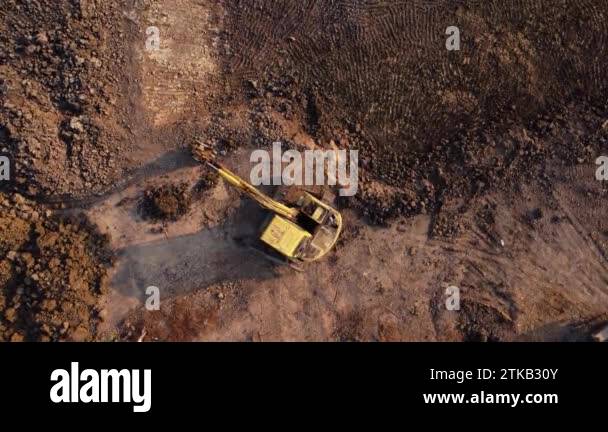 Excavator dig ground at construction site. Aerial view of a wheel ...
