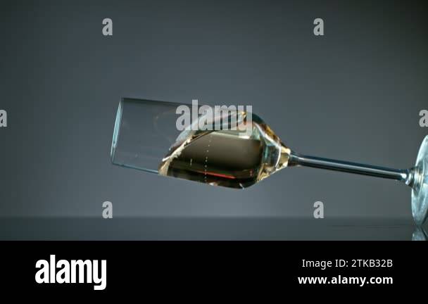 Falling Glass with Champagne on Grey Background at 1000 fps. Filmed on ...