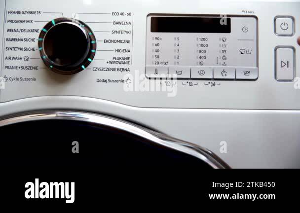The man in the washing machine, using the knob, sets the washing ...