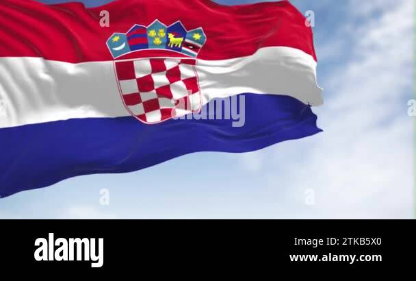 The national flag of Croatia waving in the wind on a clear day. Red ...